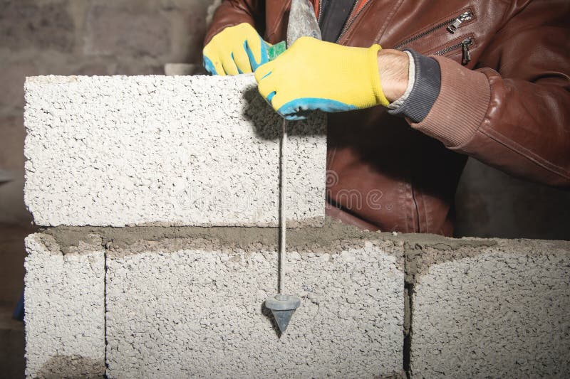 Worker Builds a Wall in the Building Site Stock Photo - Image of ...