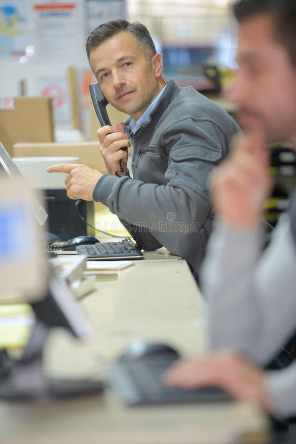 Worker in Call Center Office Talking on Phone Stock Photo - Image of ...