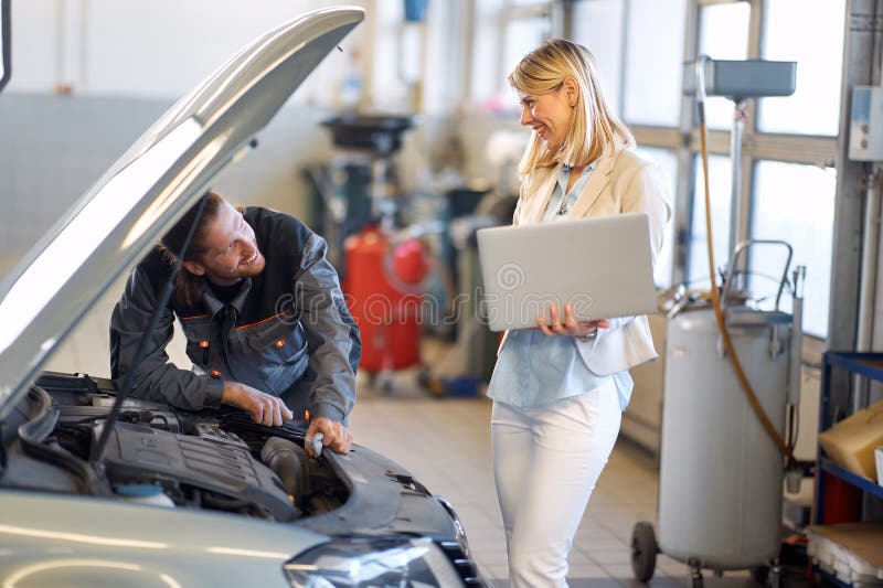 Worker in Car Workshop with Young Woman Stock Photo - Image of workshop ...