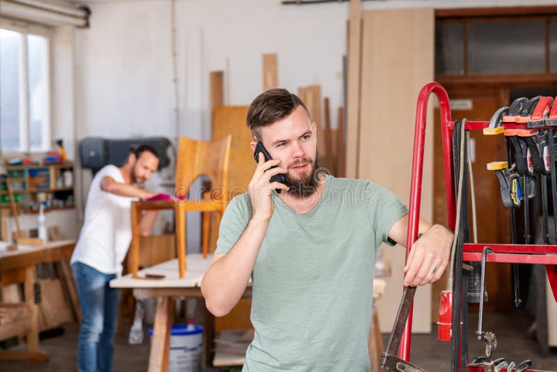 Worker in a Carpenter`s Workshop is Calling Stock Photo - Image of ...