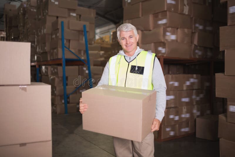 Worker Carrying Box in Warehouse Stock Photo - Image of person, smiling ...