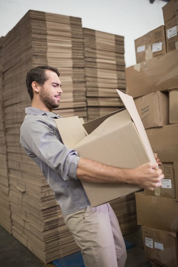 Worker Carrying Box in Warehouse Stock Photo - Image of eyes, package ...