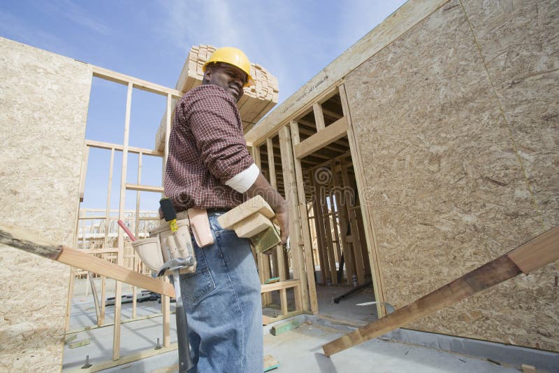 Worker Carrying Wooden Beam at Site Stock Image - Image of portrait ...