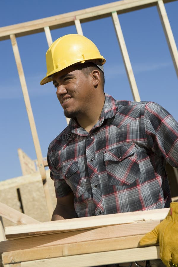 Worker Carrying Wooden Beams Stock Image - Image of site, engineer ...