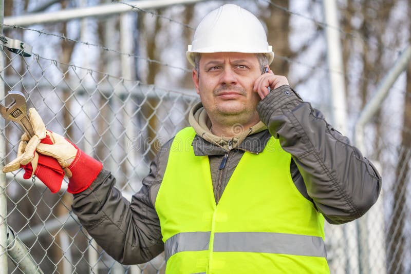 Worker with Cell Phone and Adjustable Wrench at Outdoors Stock Image ...