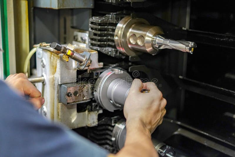 A Worker Changes a High-speed Cutter on a CNC Milling Machine Stock ...
