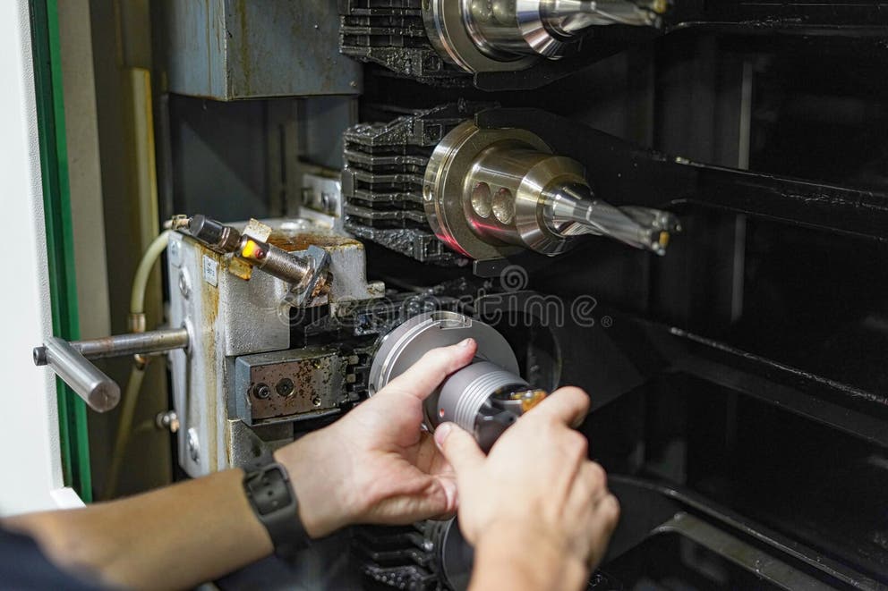 A Worker Changes a High-speed Cutter on a CNC Milling Machine Stock ...
