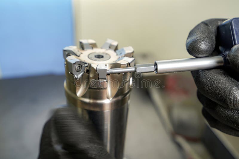 A Worker Changes a High Speed Insert on a Milling Cutter To Work on a ...