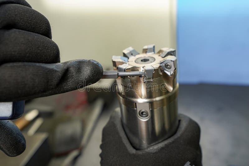 A Worker Changes a High Speed Insert on a Milling Cutter To Work on a ...