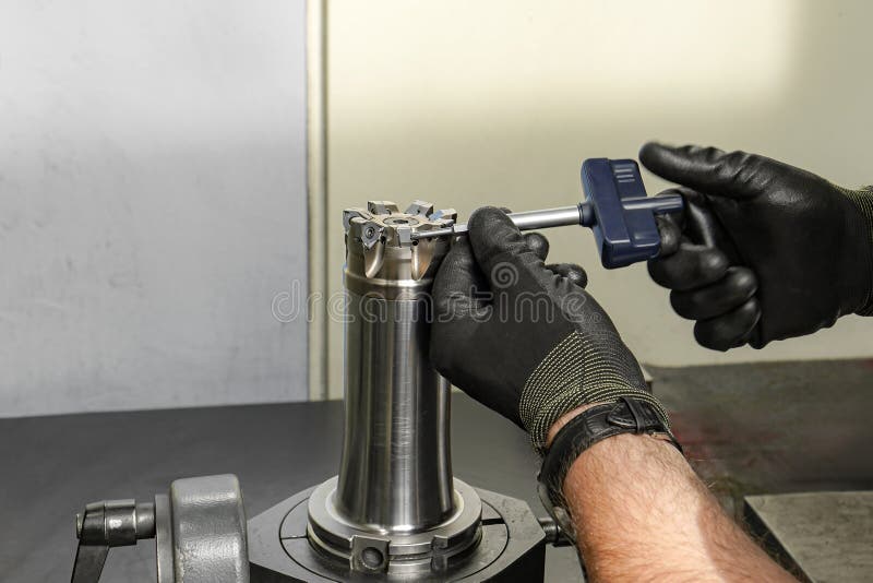 A Worker Changes a High Speed Insert on a Milling Cutter To Work on a ...