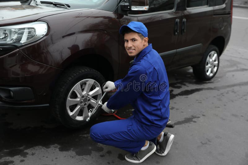 Worker Changing Car Wheel at Service Stock Image - Image of check ...