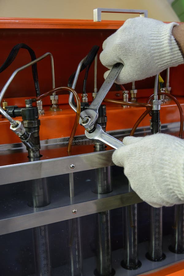 A Worker Chechs the Operation of the Fuel System at the Stand. Diesel ...