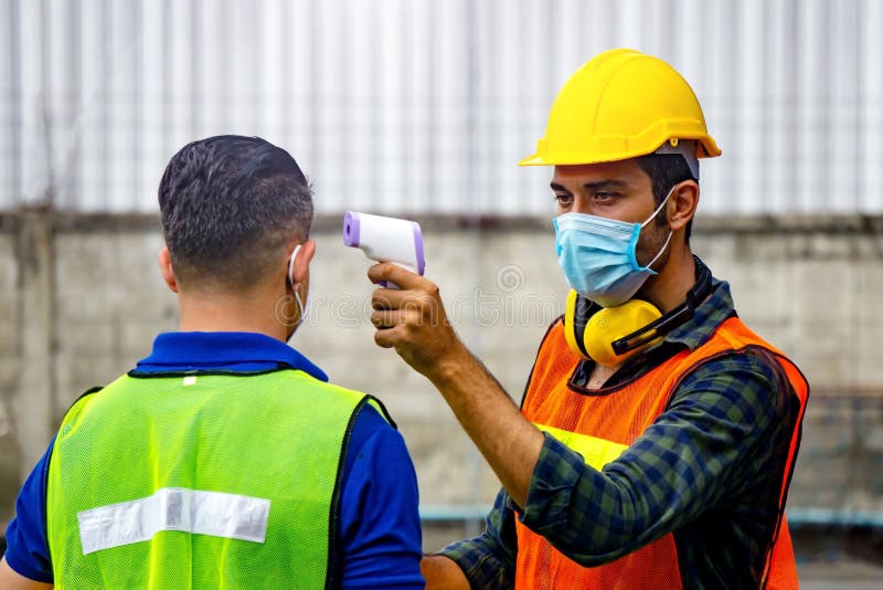Worker Check Body Temperature before Working in the Warehouse Stock ...