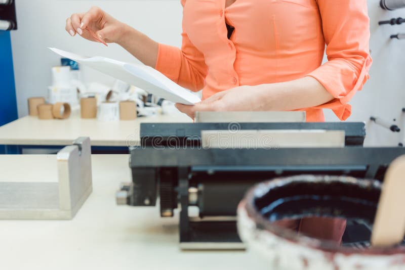 Worker Checking Design or a Print To Be Run on Printing Machine Stock ...