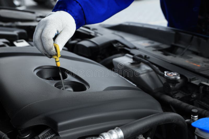 Worker Checking Motor Oil Level in Car with Dipstick, Closeup Stock ...