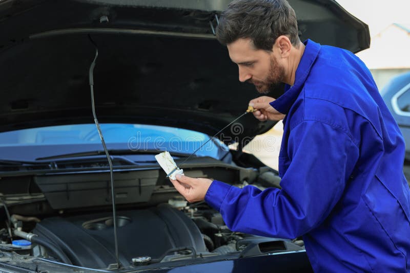 Worker Checking Motor Oil Level with Dipstick Outdoors Stock Image ...