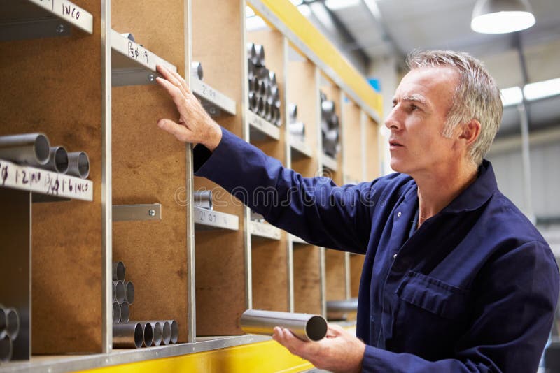 Worker Checking Stock Levels in Store Room Stock Photo - Image of ...