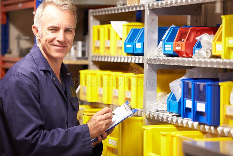 Worker Checking Stock Levels in Store Room Stock Photo - Image of ...