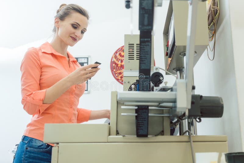 Worker Checking Textile Label Fresh from the Printing Machine Stock ...