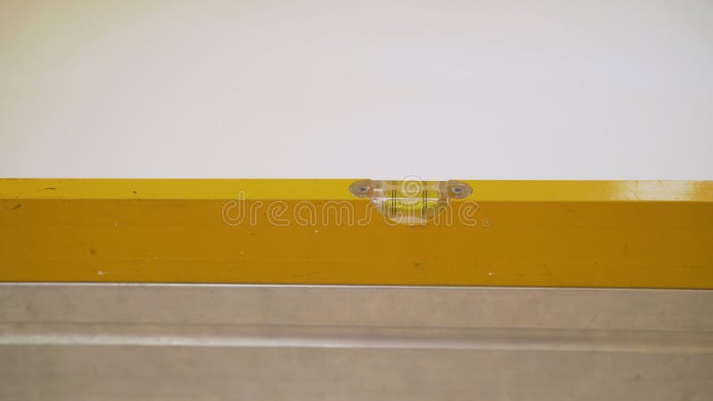 Smooth White Floor Test Tool. a Worker Checks the Floor Level Using a ...