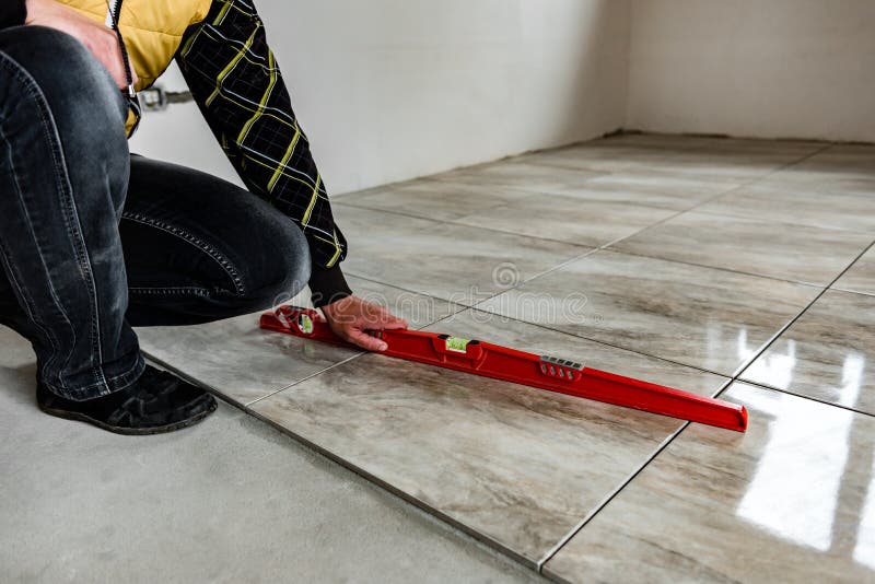 Worker Checks the Level of the Tile Floor. Stock Photo - Image of tile ...