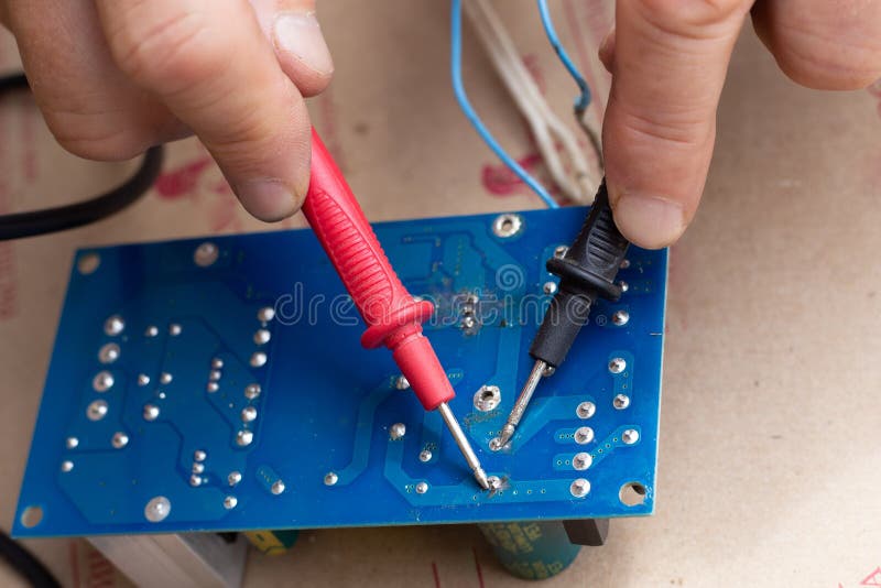 A Worker Checks the Performance of the Power Supply Using a Multimeter ...