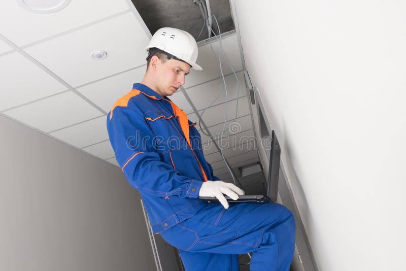 A Worker Checks the Security of the Network in the Building Stock Photo ...