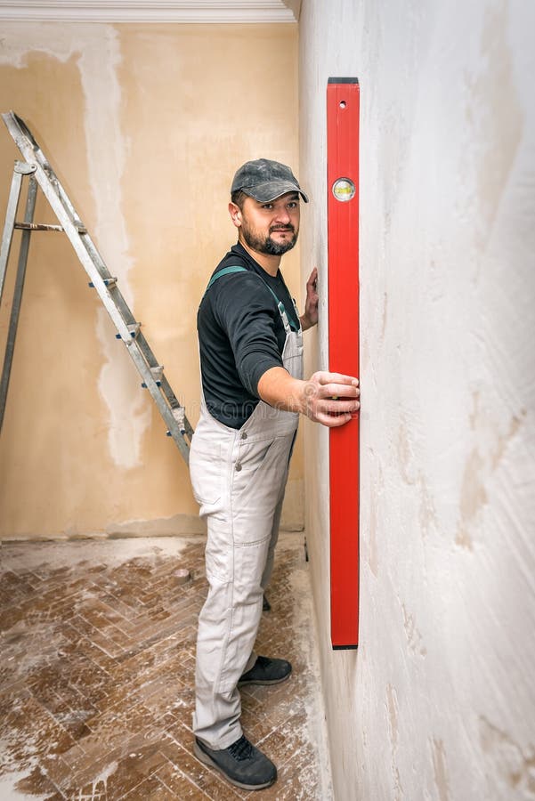 The Worker Checks the Wall Level Stock Photo - Image of check, measure ...