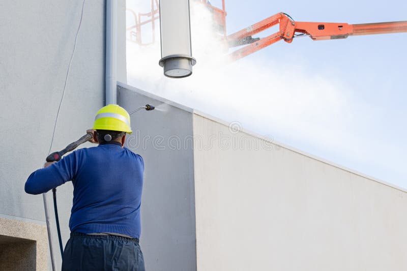 Worker Cleaning a Building Facade with High Pressure Water Jet ...