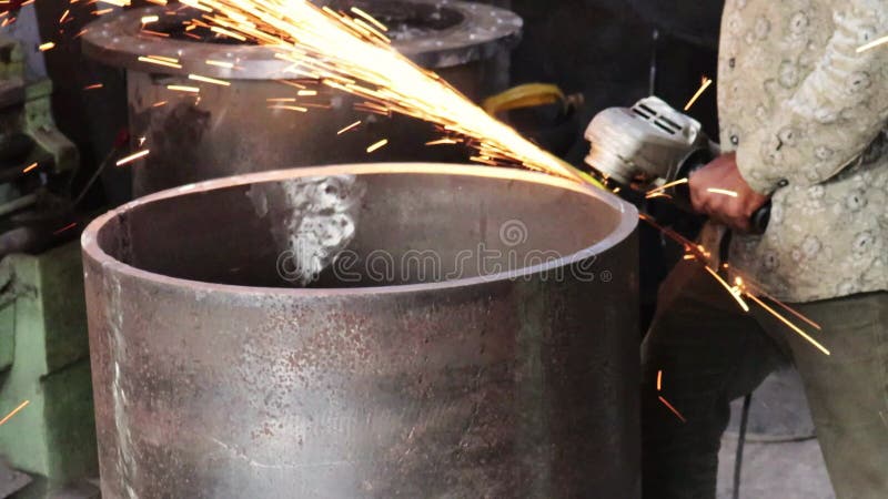 A Worker Cleaning the Edge of a Large Metal Pipe and Preparing it for ...