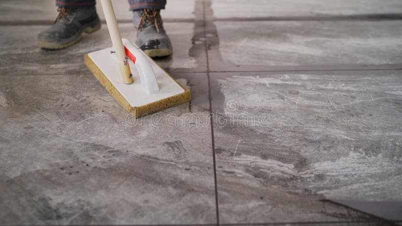 Worker Cleaning Grey Tiled Floor with Squeegee Stock Image - Image of ...