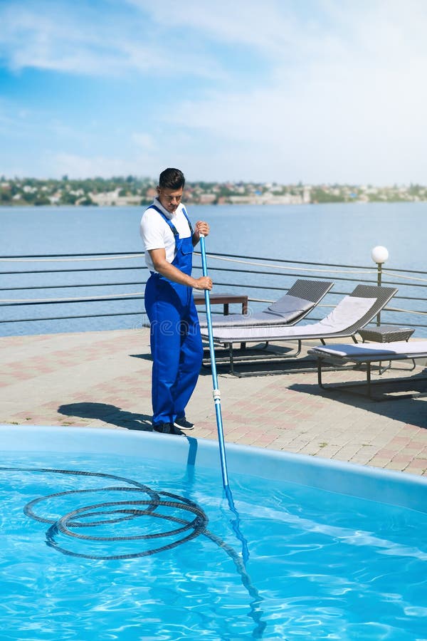 Worker Cleaning Outdoor Swimming Pool with Underwater Vacuum Stock ...