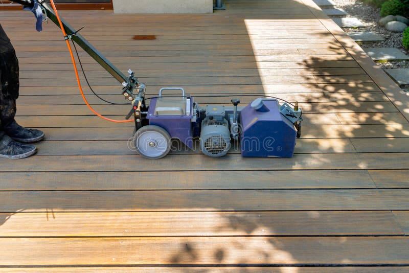 Worker Cleaning and Sanding a Wooden Deck Stock Photo - Image of ...