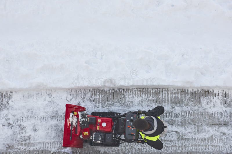 Worker Cleaning Snow on the Sidewalk with a Snowblower. Wintertime ...