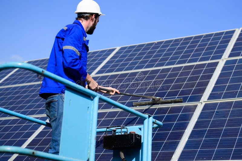 Worker Cleaning Solar Panel at Solar Cell Farm Stock Image - Image of ...