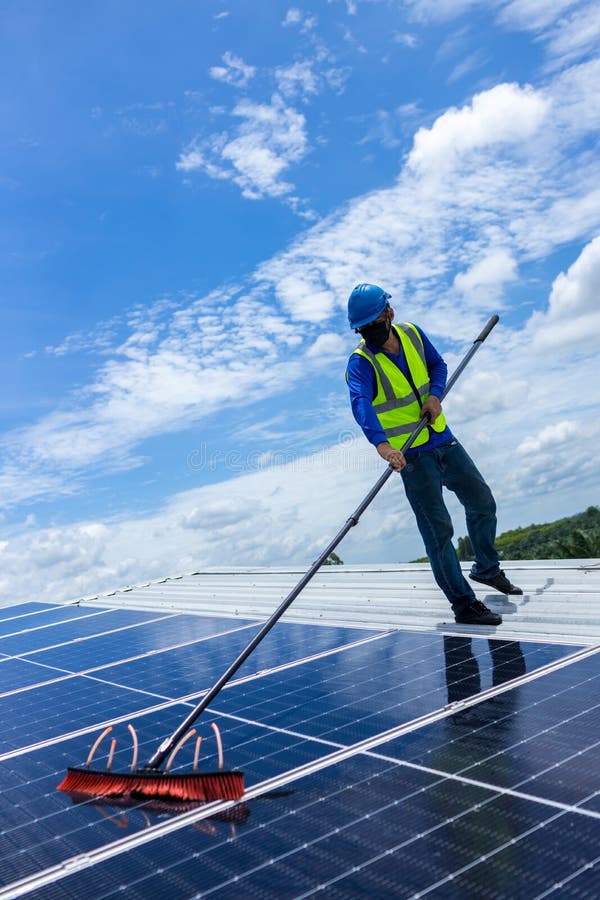 Worker Cleaning Solar Panels with Brush and Water. Worker Cleaning ...