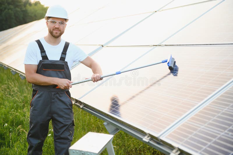 Worker Cleaning Solar Panels after Installation Outdoors. Stock Image ...