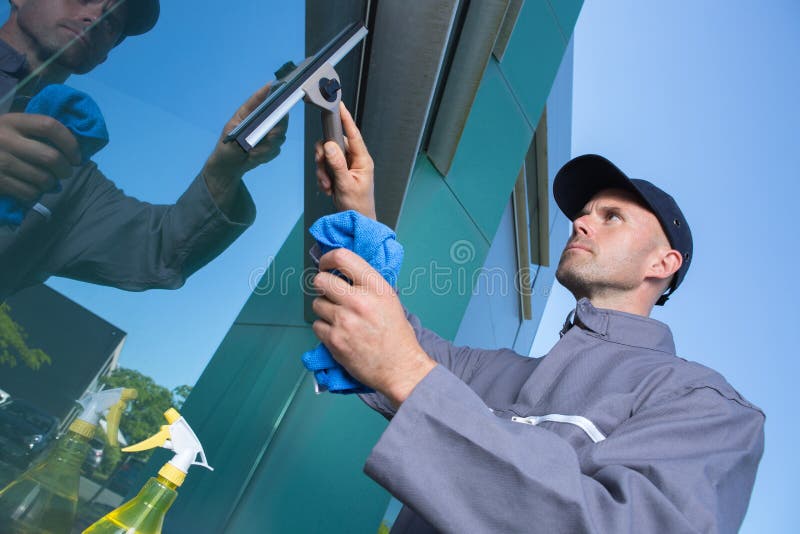 Worker cleaning window stock photo. Image of concierge - 254759706