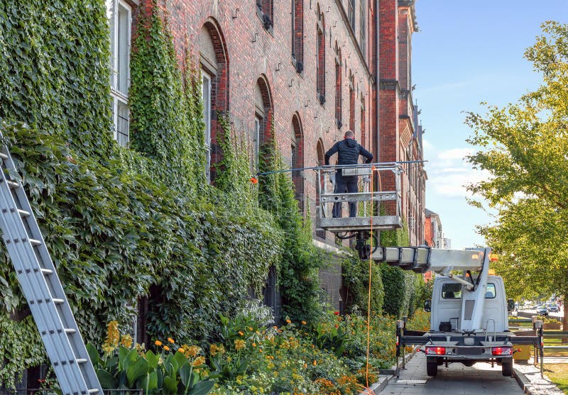 Worker Cleaning the Window of a Building at Heigt in Lifting Cradle ...