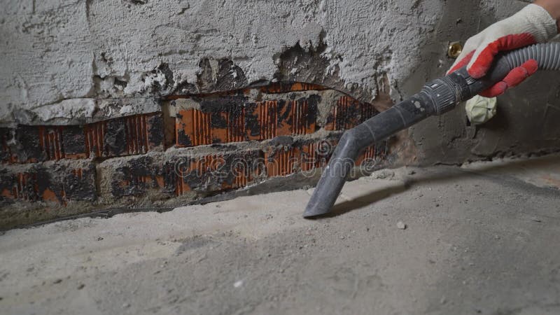 Construction Worker Vacuuming on a Construction Site. a Worker Cleans ...