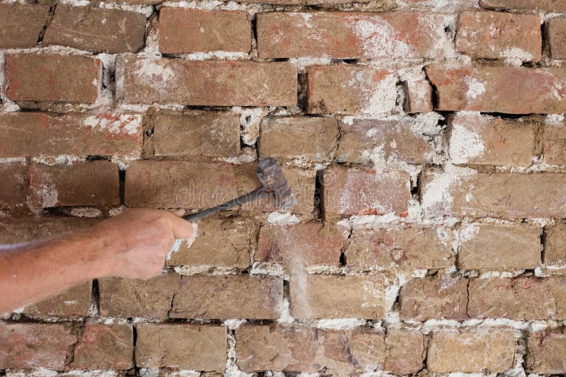 A Worker Cleans an Old Brick Wall with a Chisel. Renovation of an Old ...