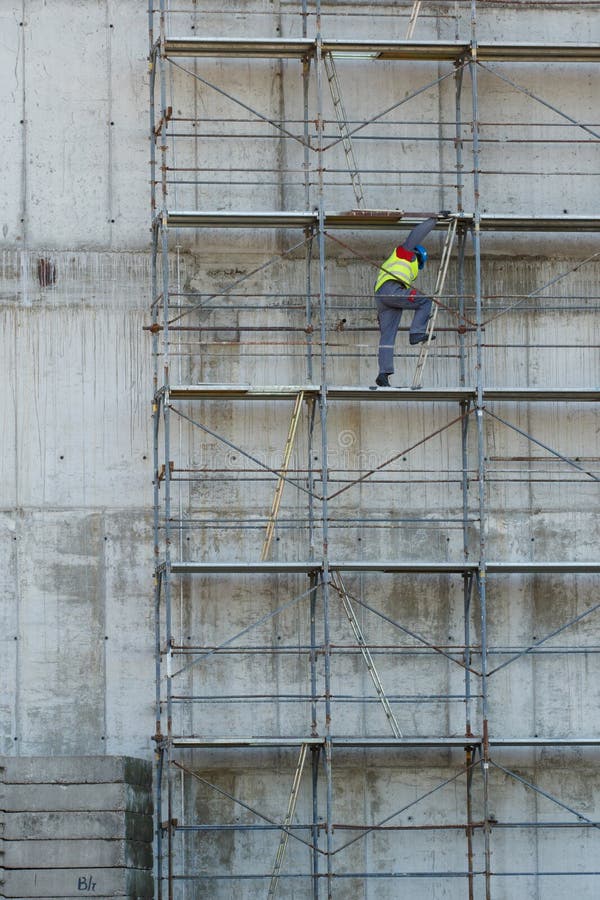 Construction Worker Climbing Ladder On Building Site Stock Image ...