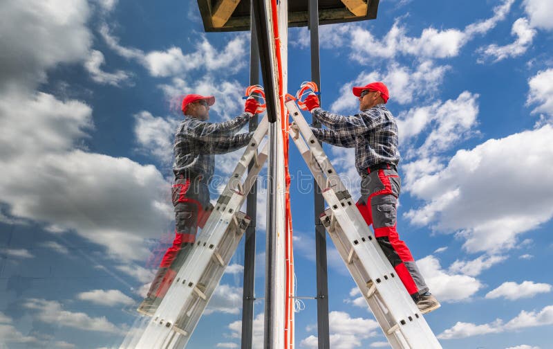 Worker Climbing Ladder for Maintenance on a Clear Day Stock Photo ...