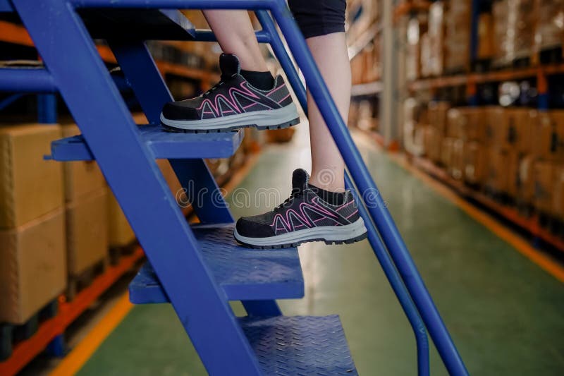 A Worker is Climbing Stairs in a Warehouse Stock Photo - Image of ...