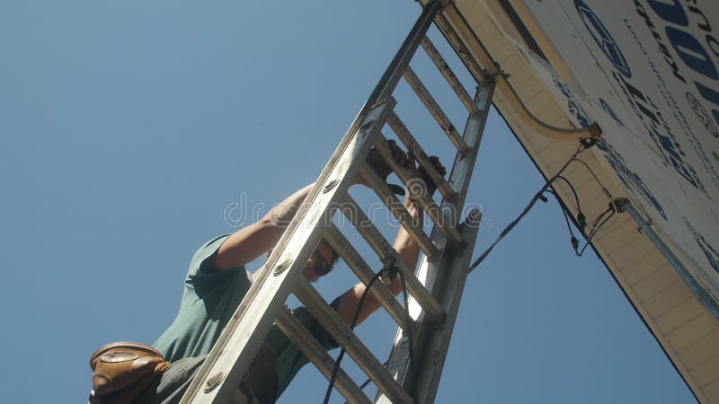 Man climbing down a ladder stock video. Video of build - 233202955