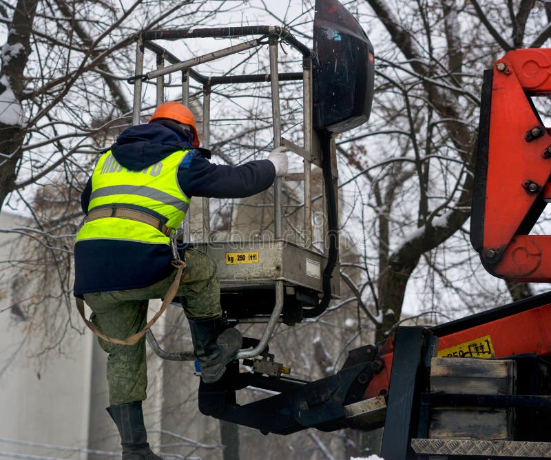 The Worker Climbs on the Elevator To Perform Work Stock Photo - Image ...
