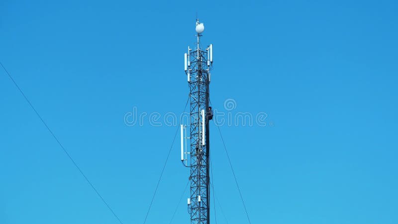 Worker Climbs Up a Mobile Phone Tower. Two Workmen on Cell Tower Stock ...