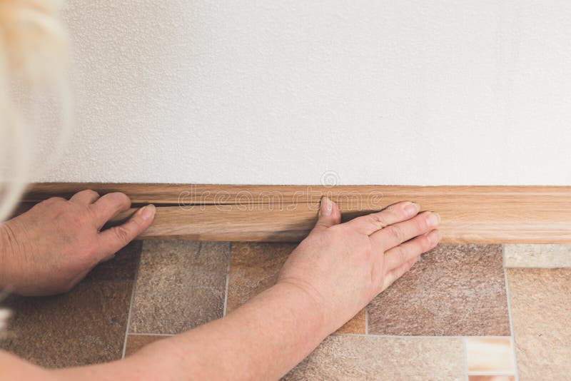 Installation of Plastic Floor Plinth. Interior Details. Stock Image ...