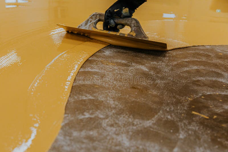 Worker Apply Coating Floor with Self-leveling Epoxy Resin in Industrial ...