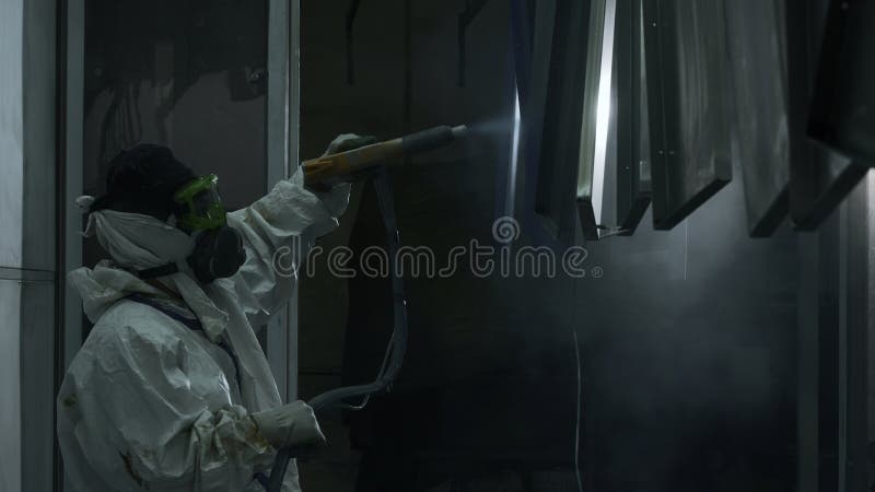 A Worker Coats a Metal Part with a Powder Coating Using a Spray Gun ...